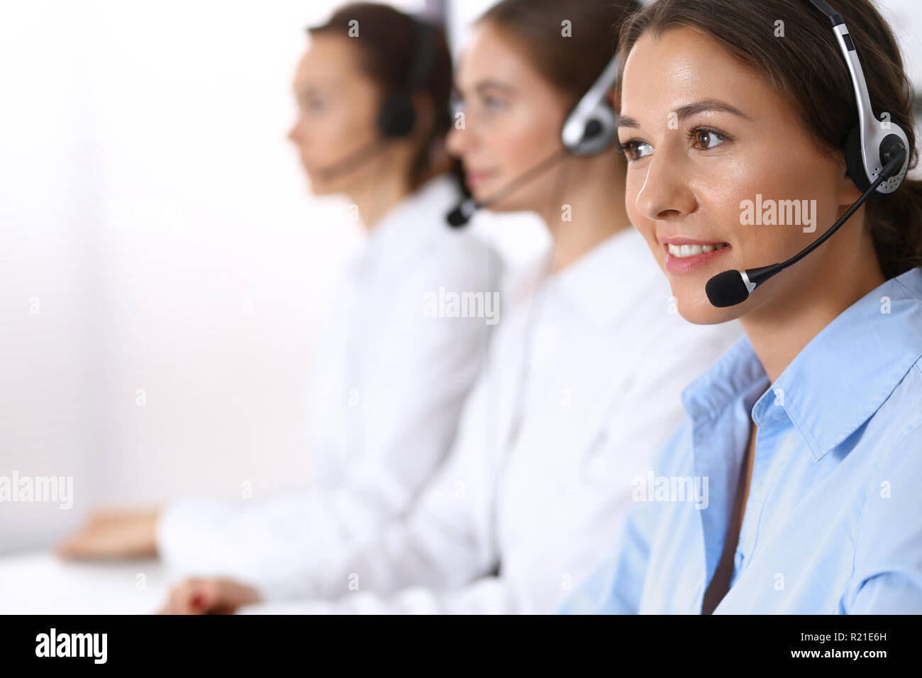Call center. Group of operators at work. Focus at beautiful business woman in headset Stock ...