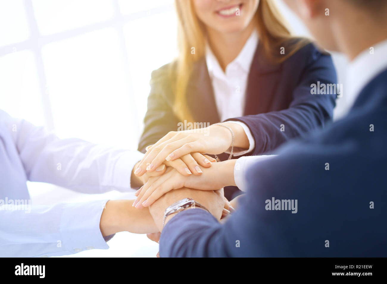 Business team showing unity with their hands together. Group of people ...