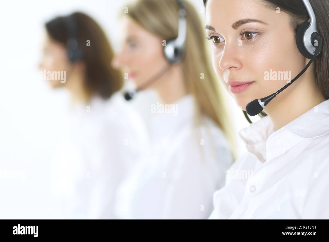 Group of call center operators at work. Focus on beautiful business ...