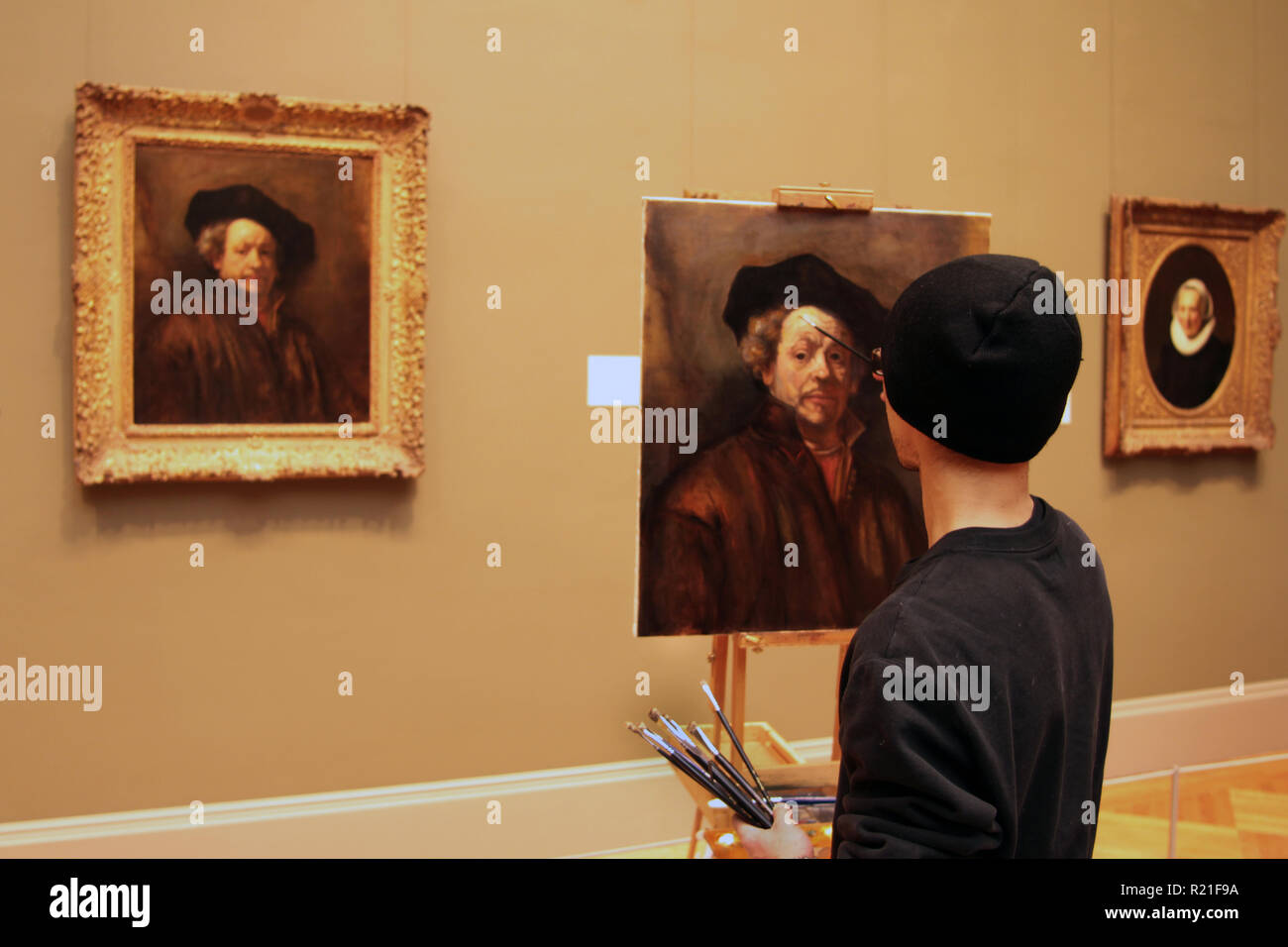 An art student is copying a Rembrandt painting to improve his skills in ...