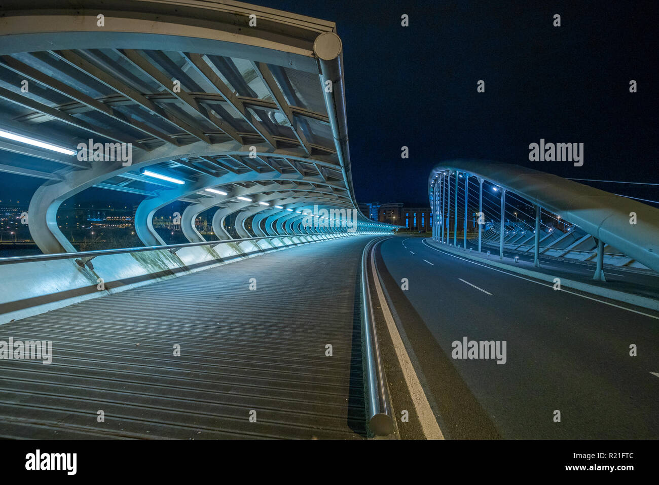 modern white bridge illuminated in blue Stock Photo - Alamy