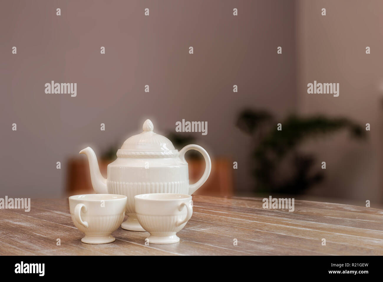 tea pot and cups on wooden table, still life in a home vintage design ...