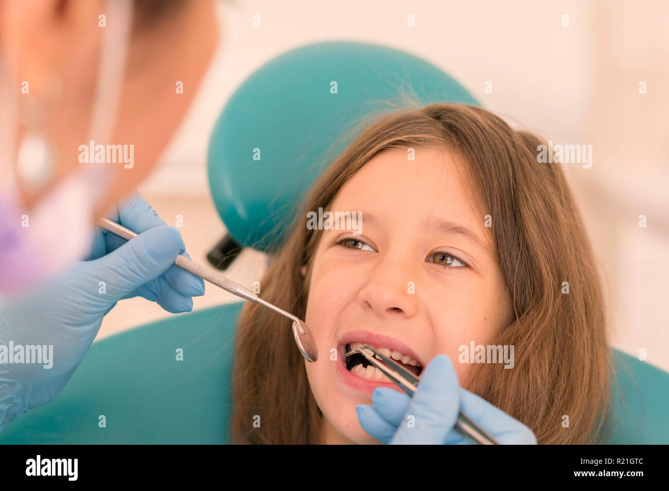 Macro close up of young child with open mouth at dentist. Teeth checkup at dentist's office ...