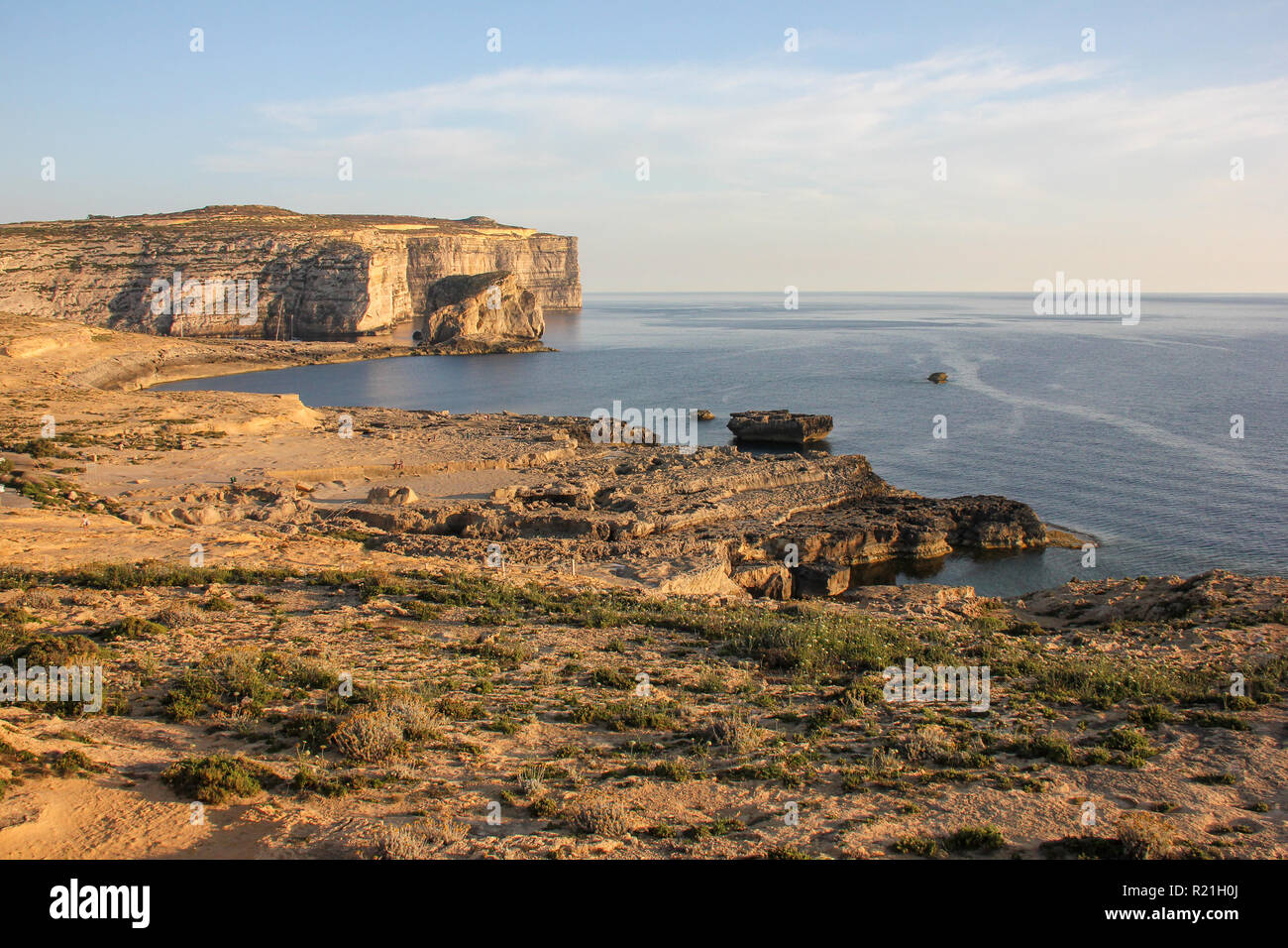 Beautiful view of Dwejra coast vertical sheer cliff at sunset. Gozo ...