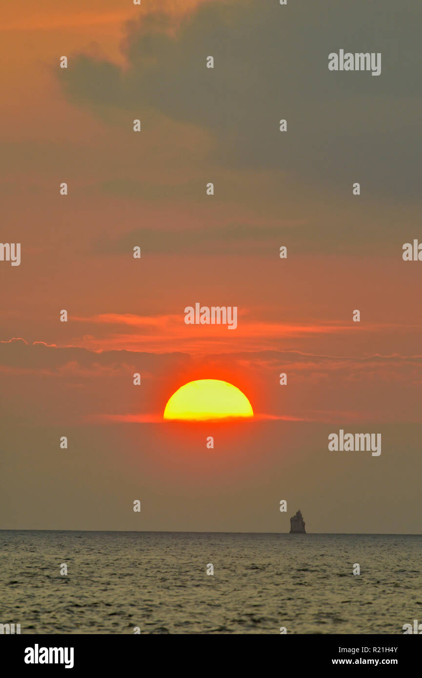 Sunset over the Pacific Ocean with a distant island, Galapagos Islands ...