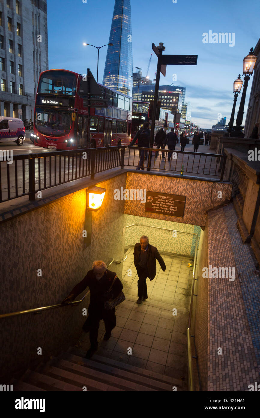 With the Shard in the background, a man and woman climb the steps of ...