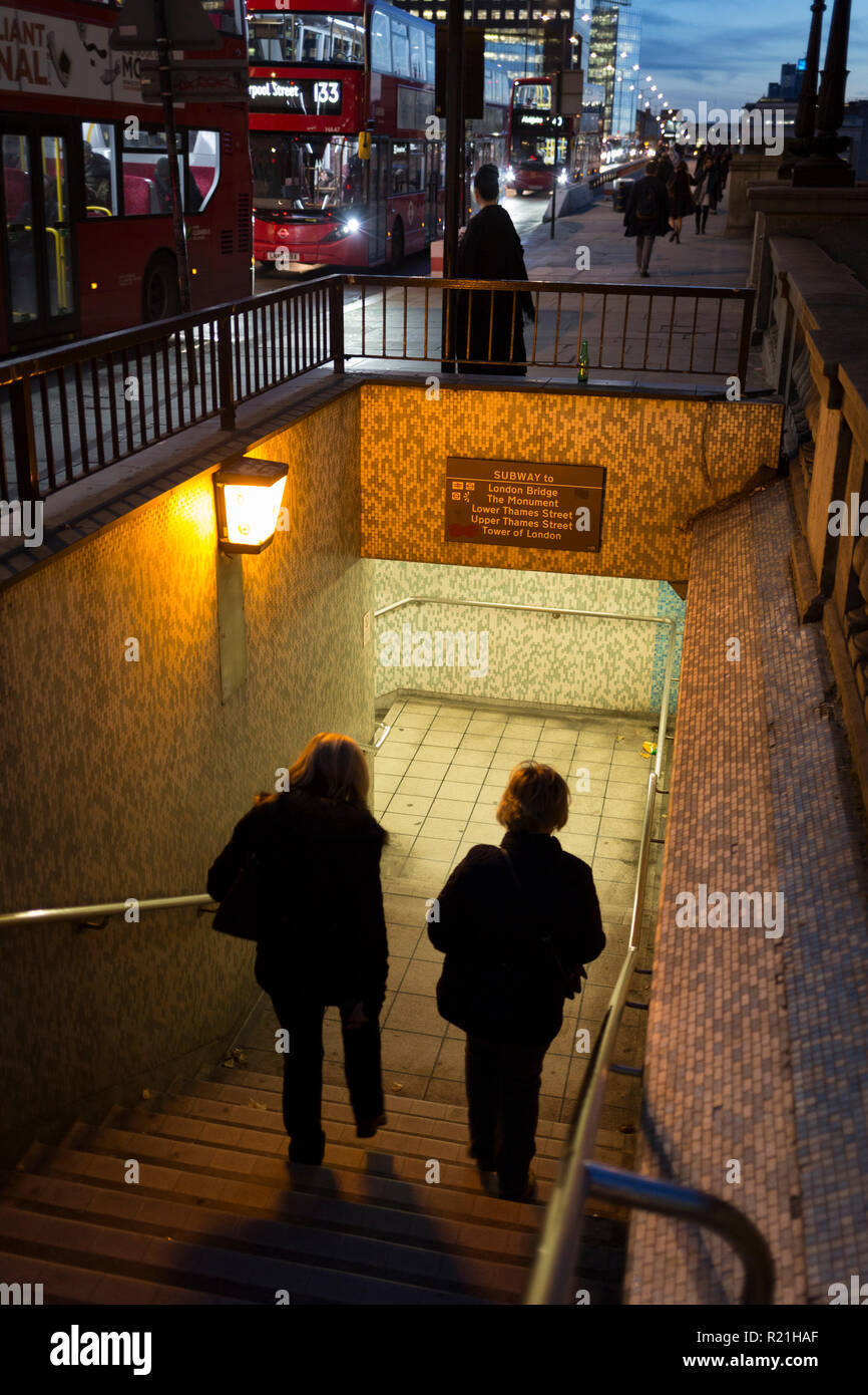 Two women descend steps into the tunnel under London Bridge during the ...