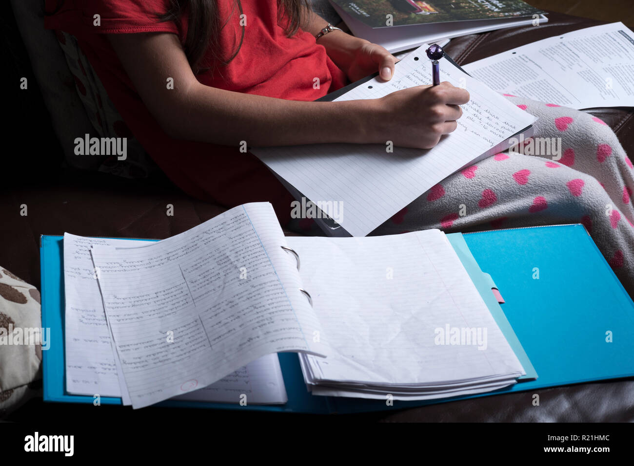 UK,Teenage girl works on her homework in bed Stock Photo - Alamy