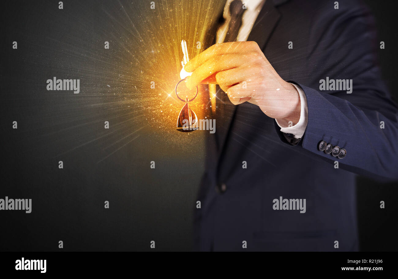 Formal man hand over shiny keys with dark background Stock Photo - Alamy