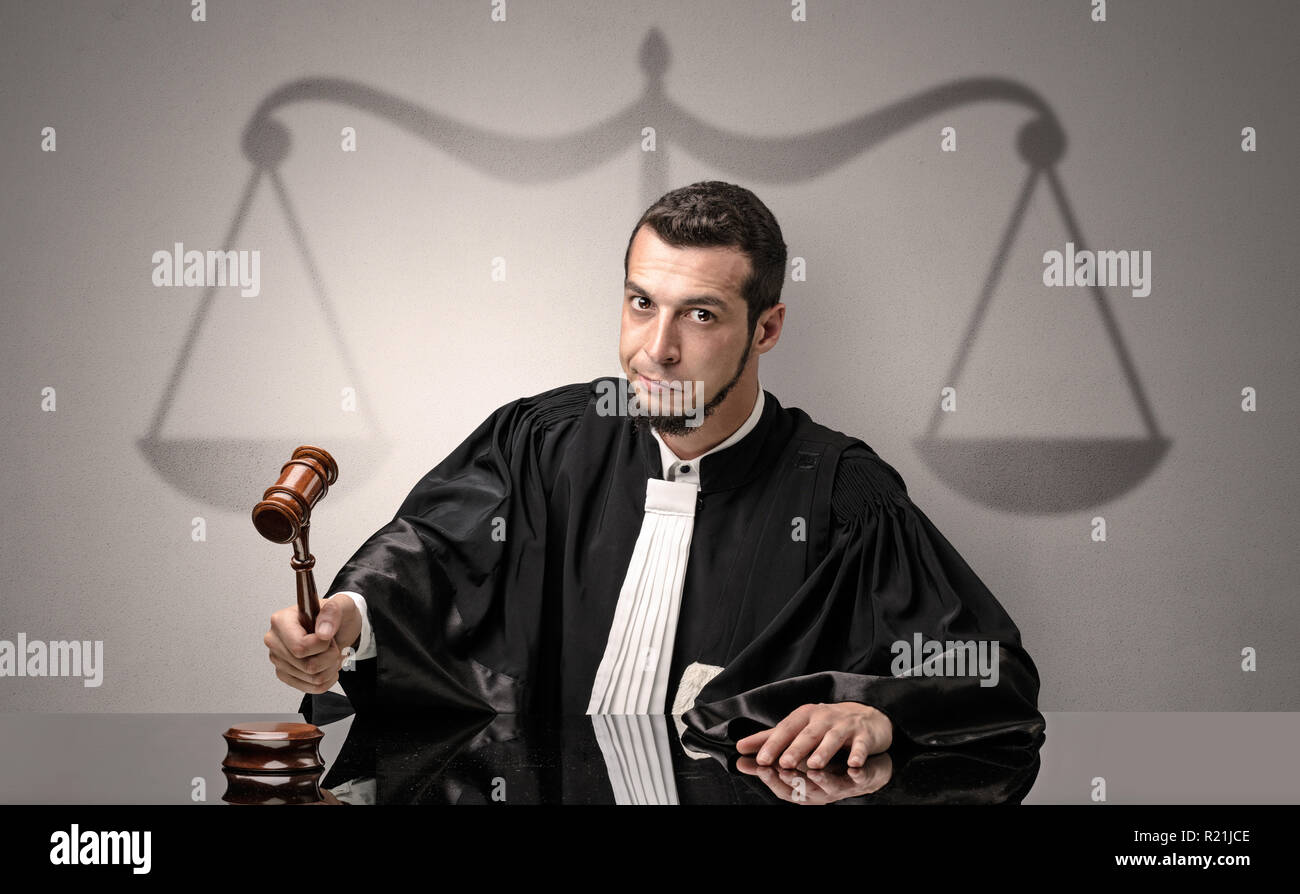 Young handsome judge in black gown making decision Stock Photo - Alamy