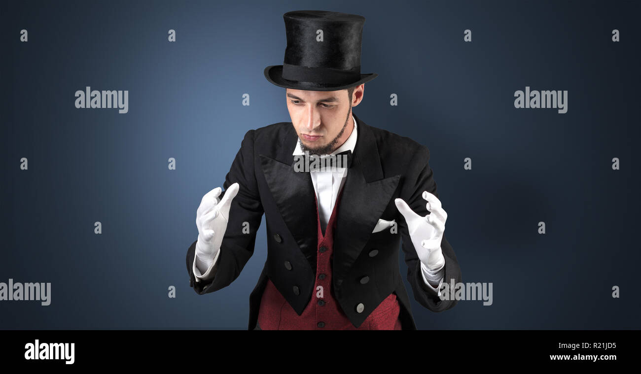 Handsome magician with no graph holds something invisible Stock Photo ...