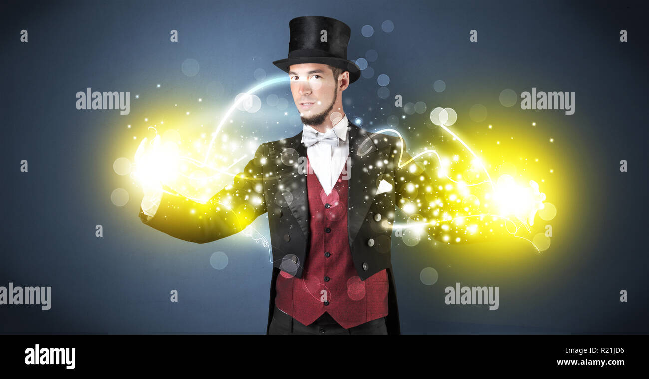 Magician holding his sparkling power between his two hand Stock Photo ...
