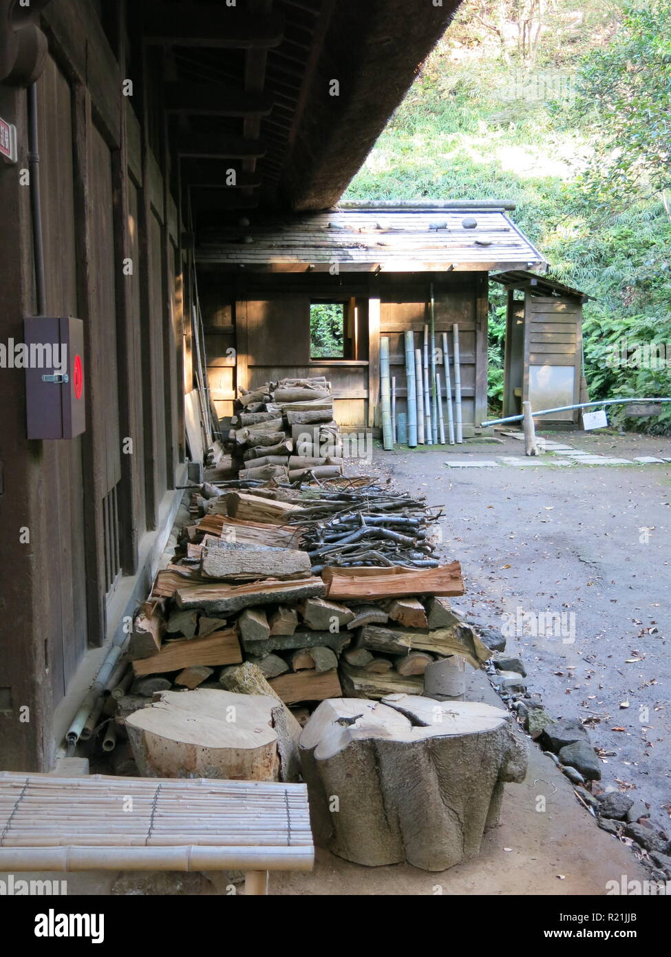 Log-piles surround the exterior of Yanohara farmhouse, one of many ...