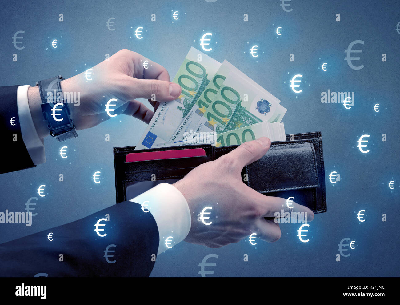 Businessman's hand takes out euro from a wallet with euro symbol ...