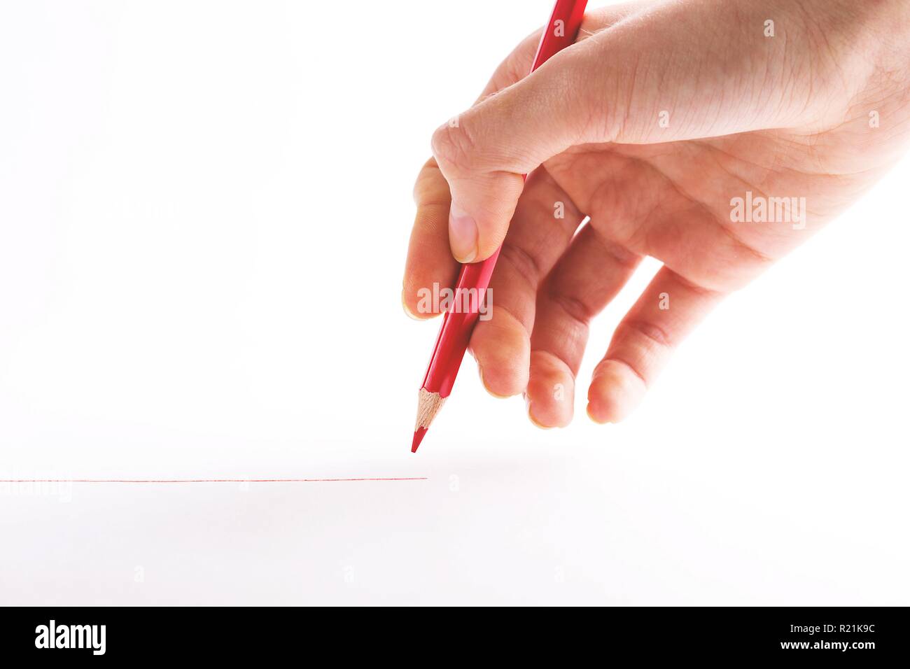 hand with the red pencil on a white background Stock Photo - Alamy