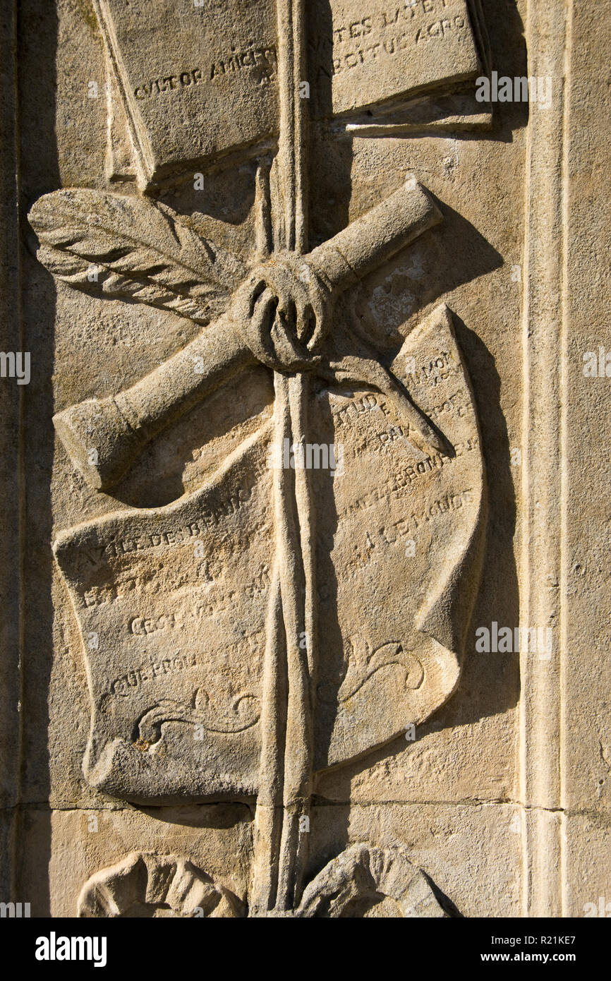 A pen and paper carved in stone around the door of Chateau de Cirey in ...