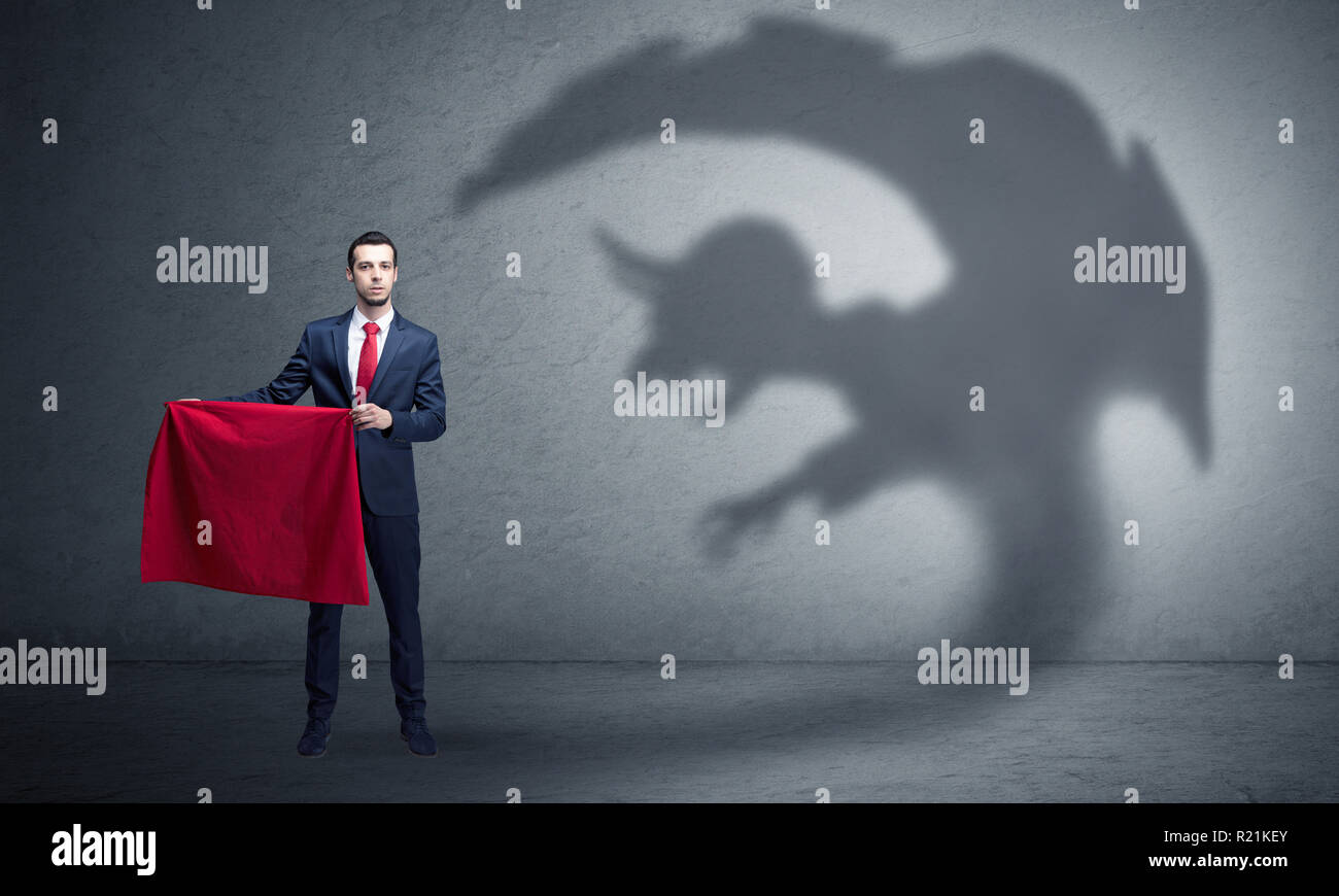 Businessman standing with red cloth in his hand and imp shadow on the ...