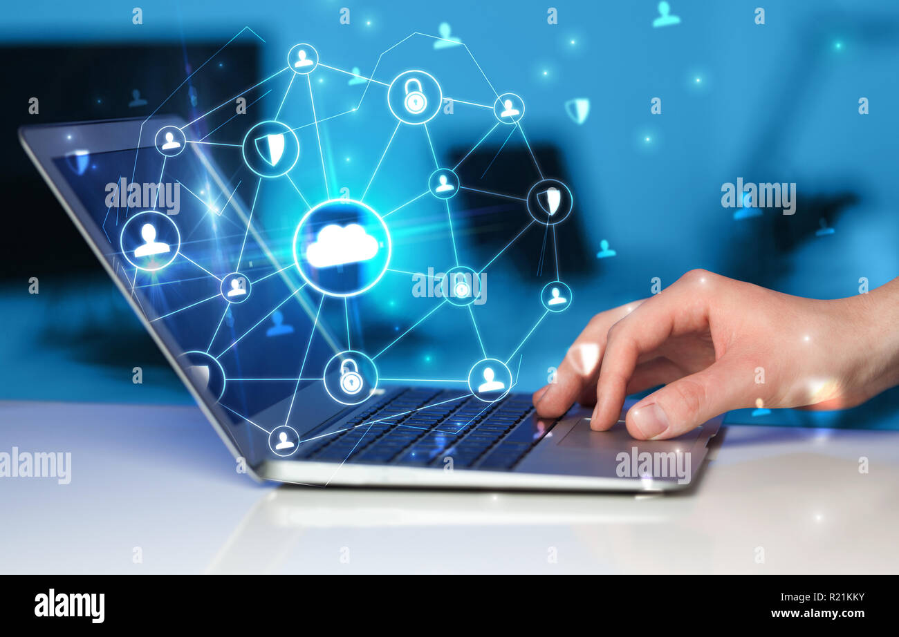Hand using laptop with centralized cloud computing system and network ...