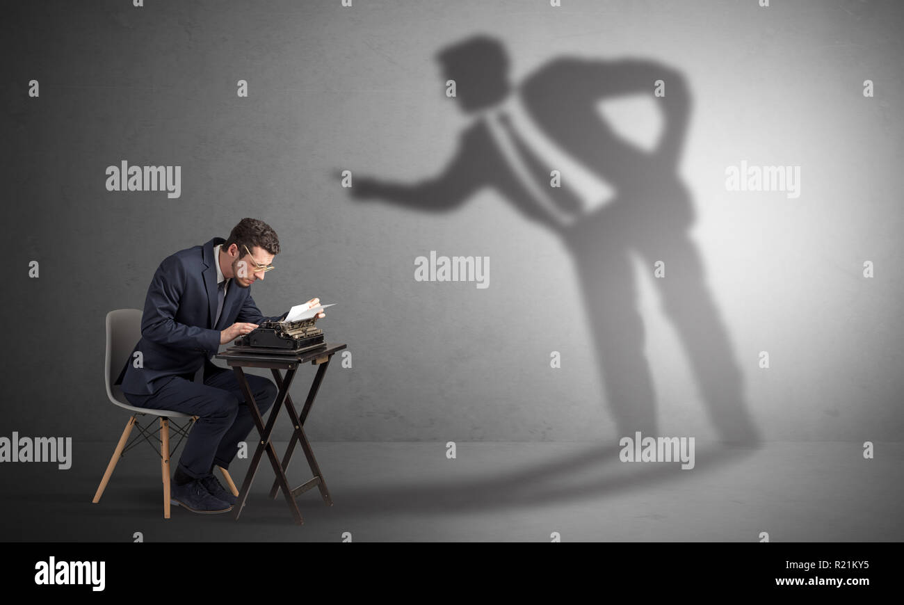 Little man working and a big shadow arguing with him Stock Photo - Alamy