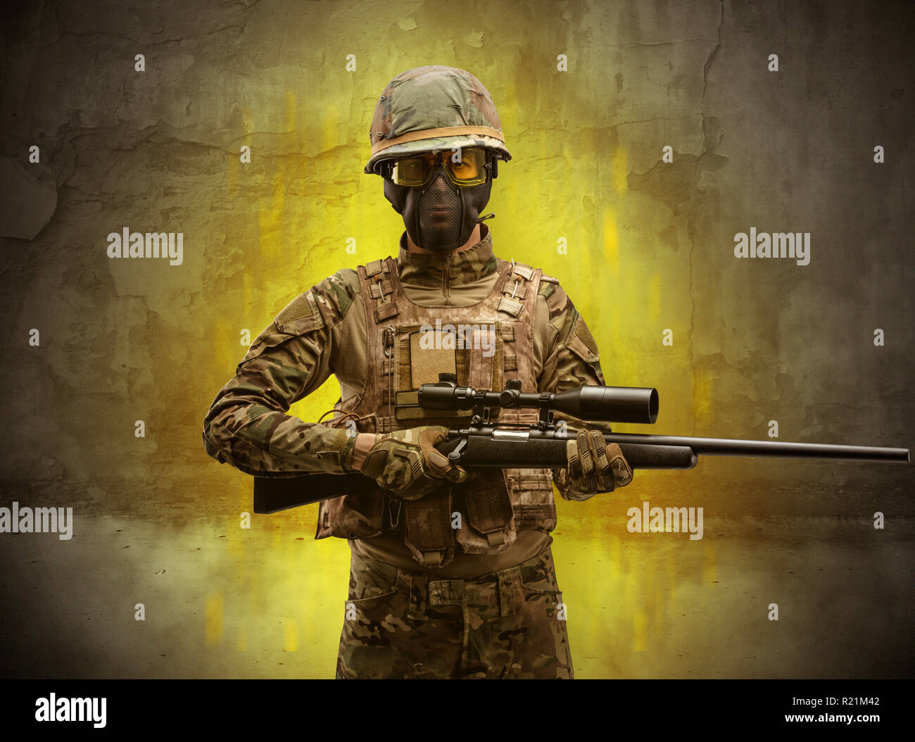 Hazard, menace soldier in a ruined crumbly building with arms on his ...