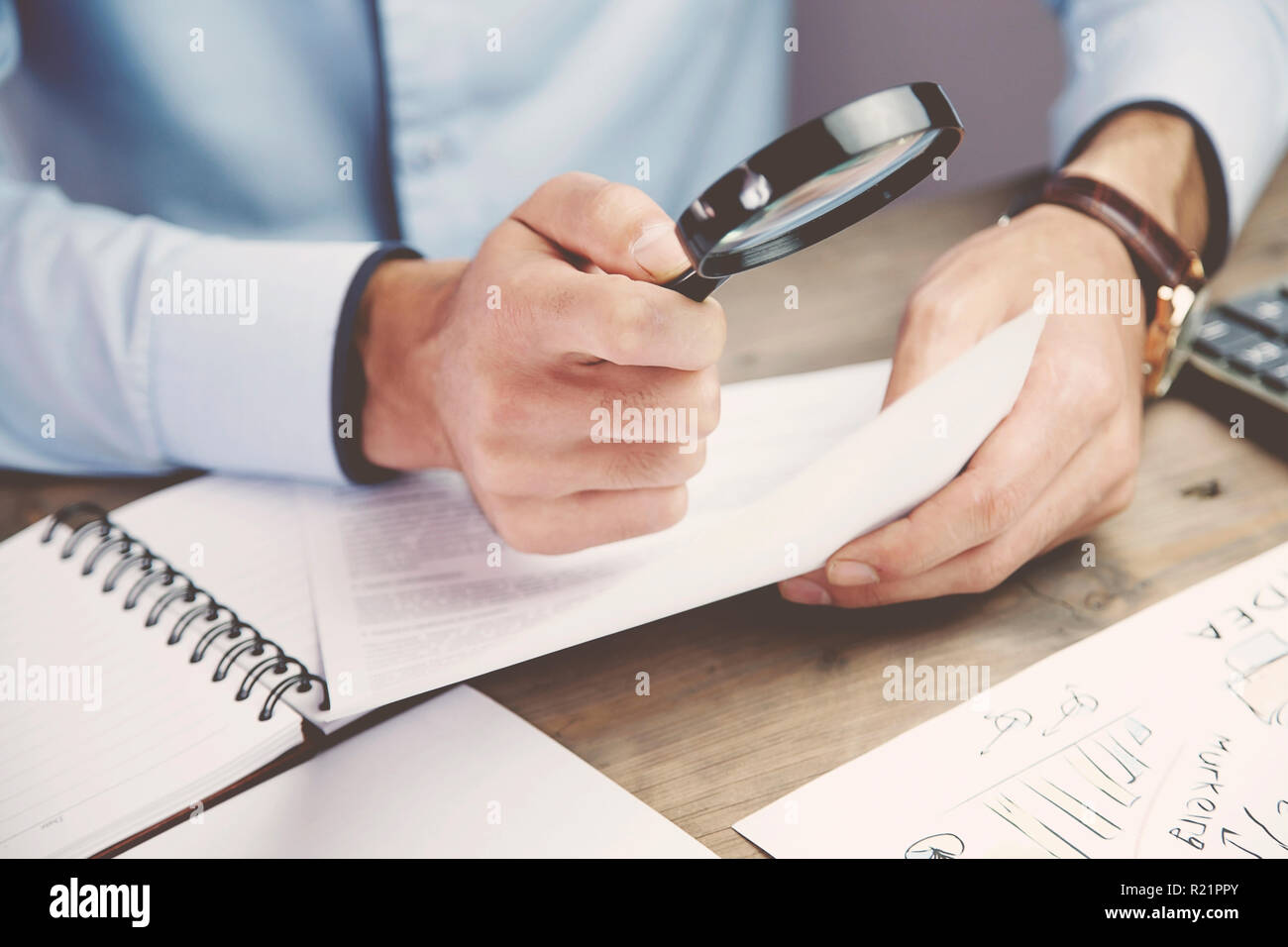 Businessman magnifying glass reading documents hi-res stock photography ...