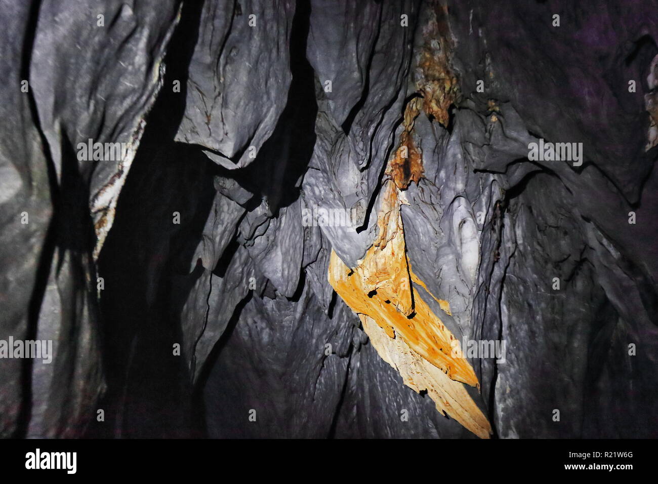 Rock formations of grey limestone with speleogens and reddish ...