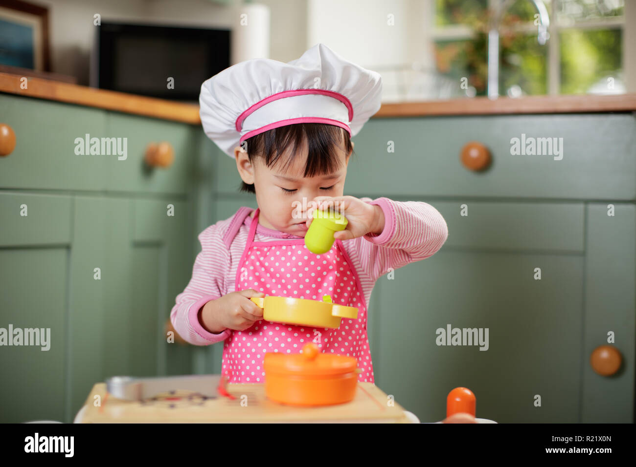 toddler baby girl pretend play baking bread Stock Photo - Alamy