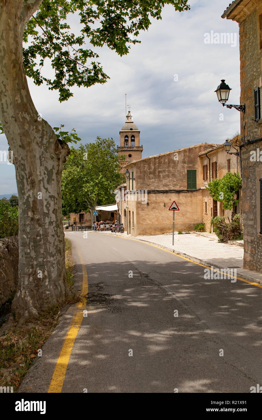 Street and lantern and bar and Bell Tower in a small spanish village ...
