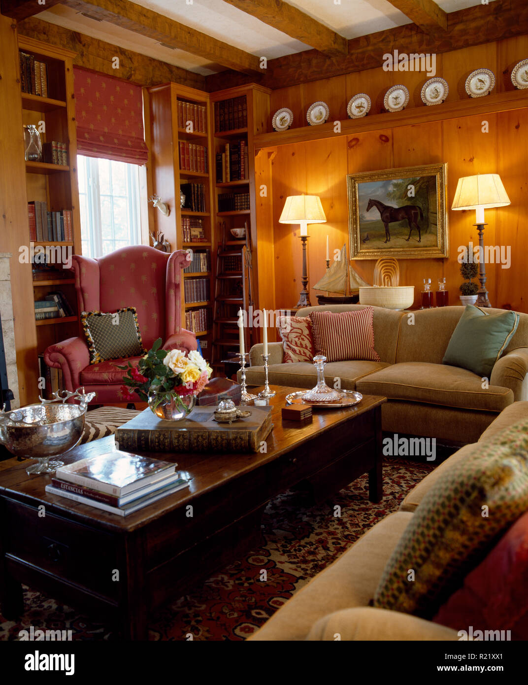 Lighted lamps and vintage wooden coffee table in sitting room Stock ...