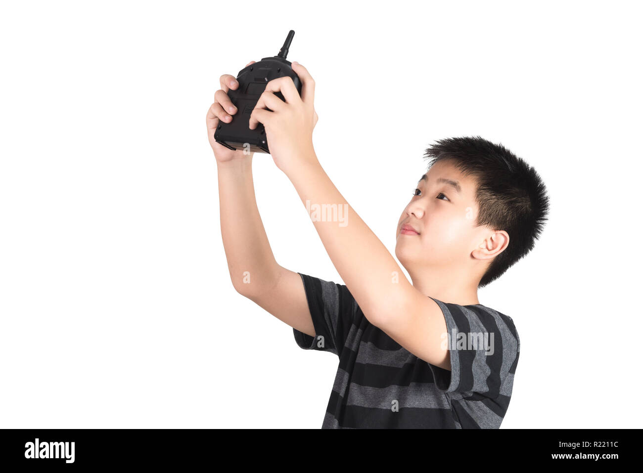 Asian boy holding radio remote control (controlling handset) for ...