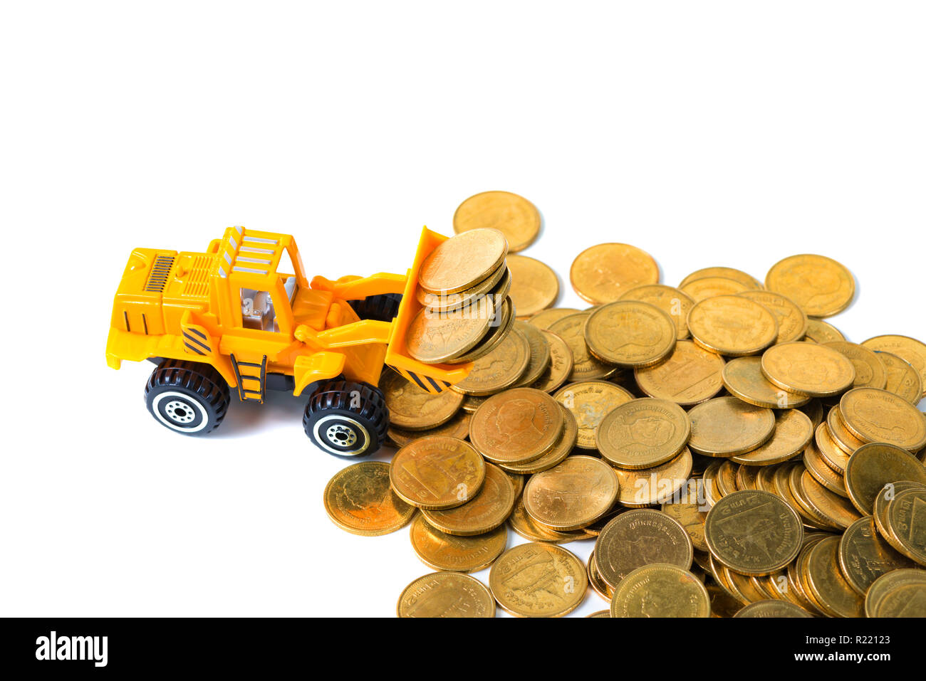 Mini bulldozer truck loading stack coin with pile of gold coin ...
