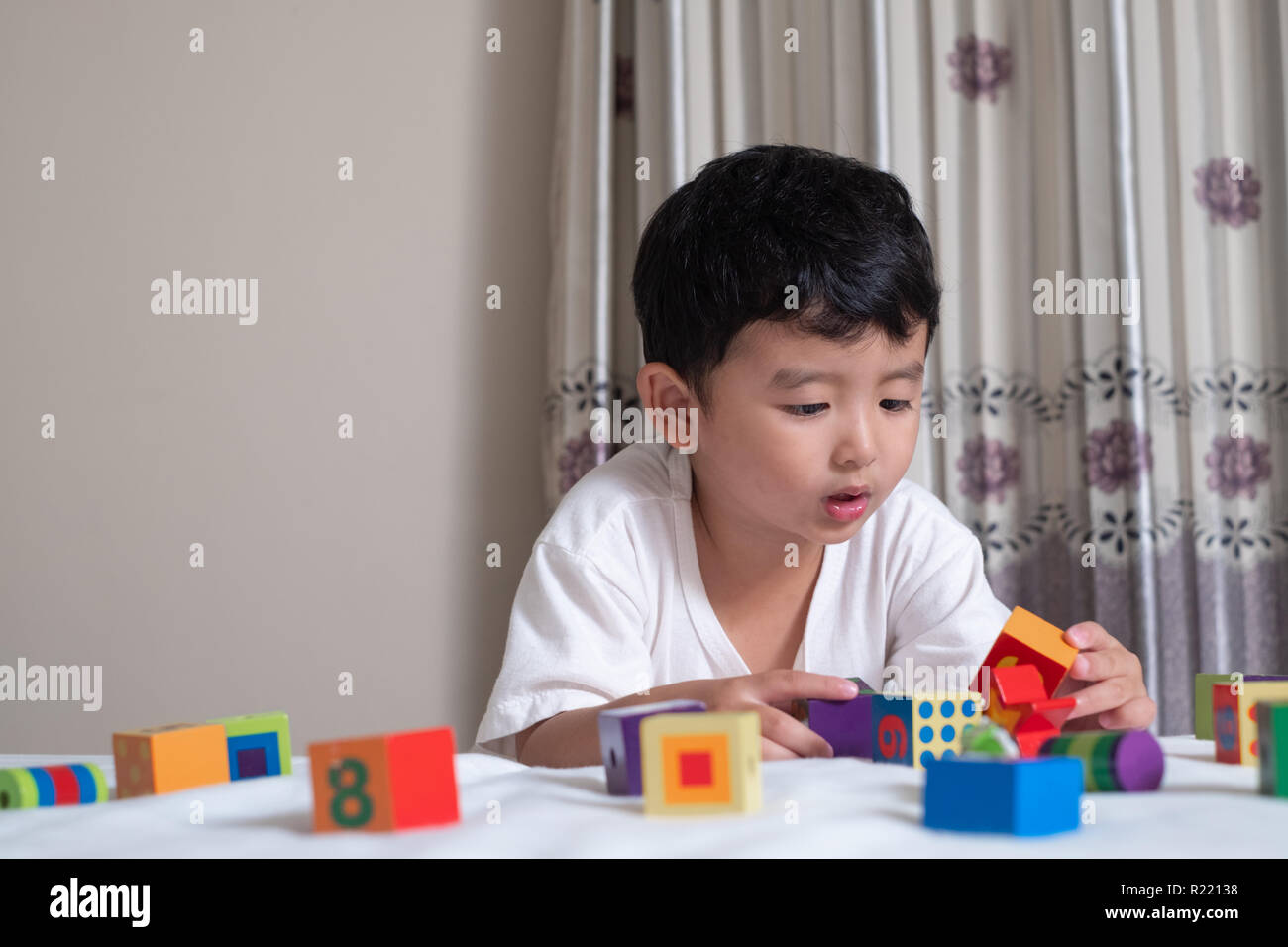 3 years old little cute Asian boy play toy or square block puzzle at ...