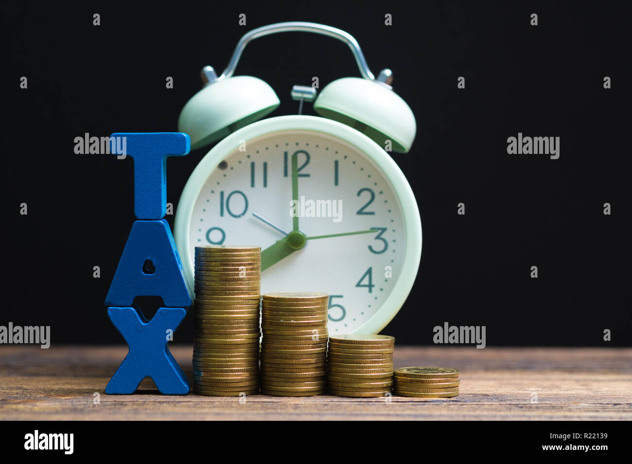Time to pay TAX concept. TAX alphabet with stack of coin and vintage ...