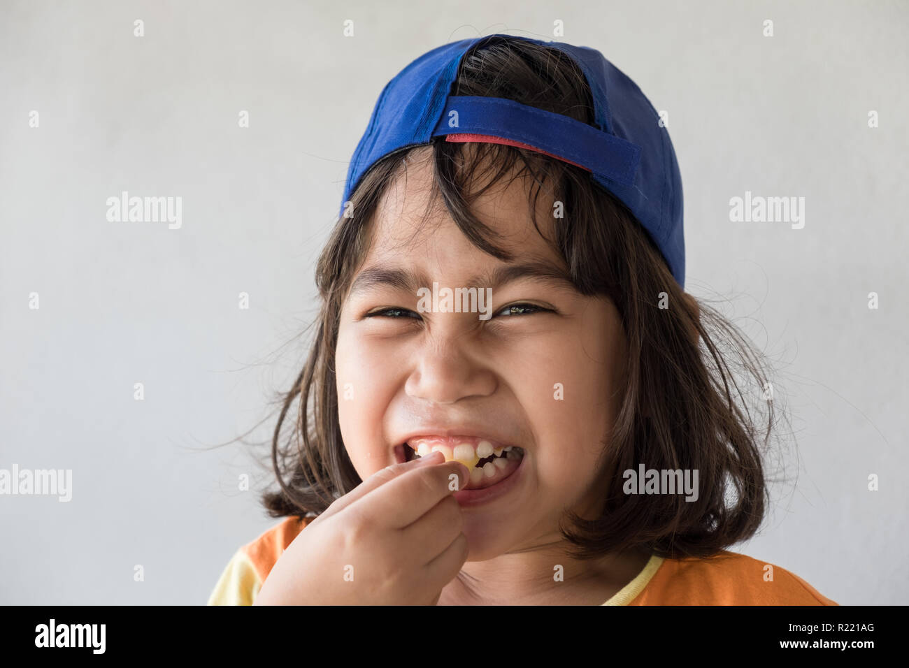 Emotions from the sour on the girl's face Stock Photo - Alamy