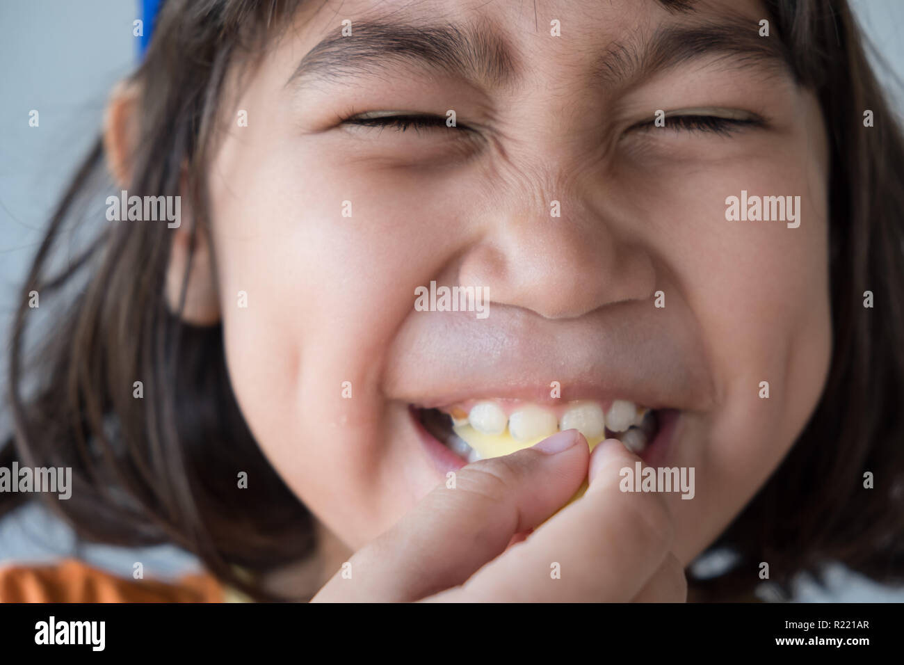 Emotions from the sour on the girl's face Stock Photo - Alamy