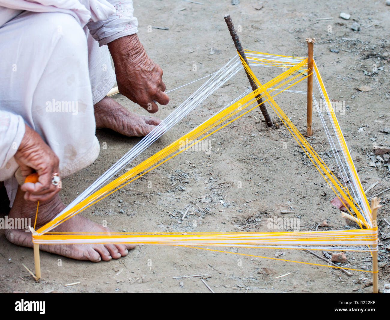 An old woman working with threads Stock Photo - Alamy