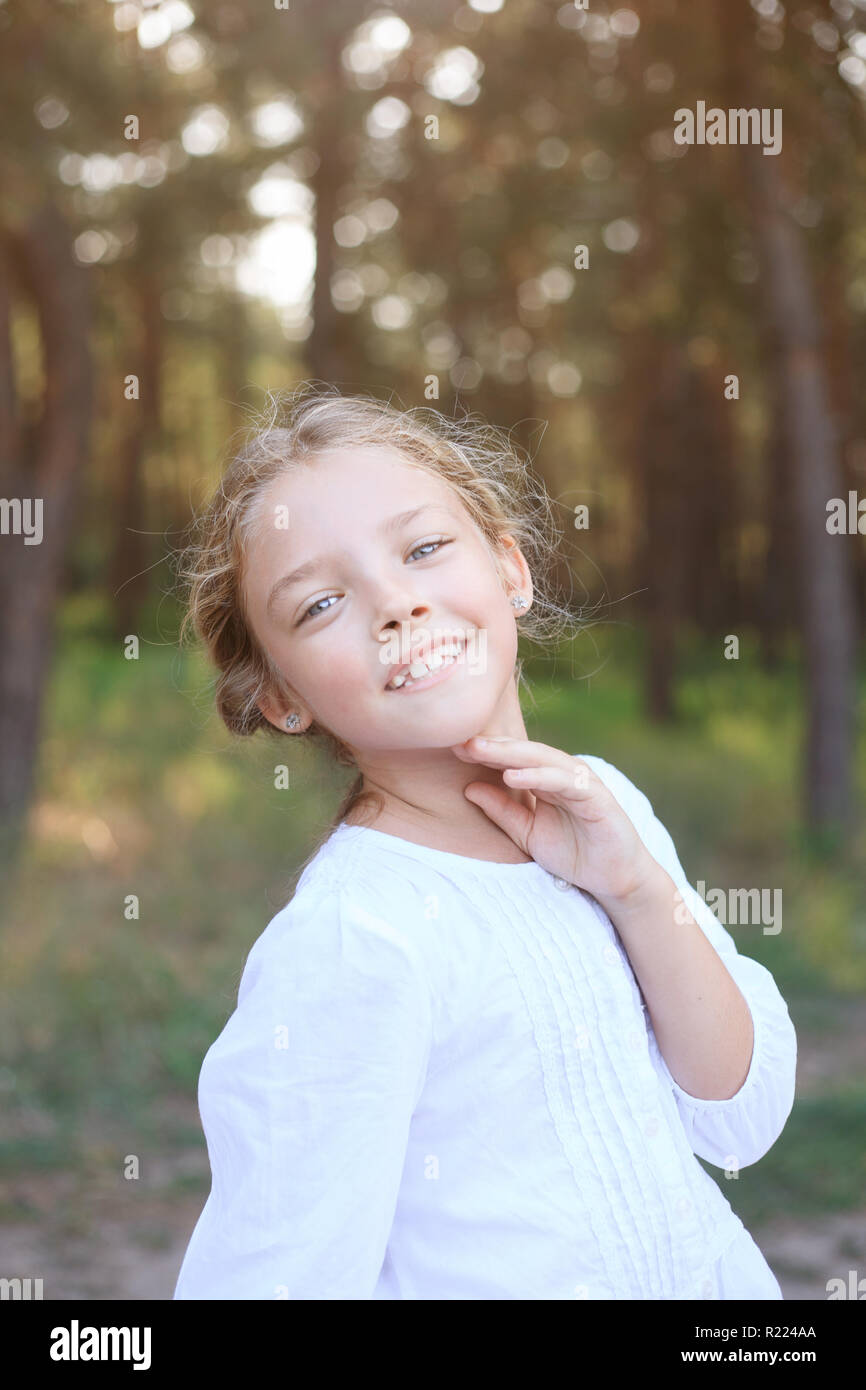 Cute little girl of preschool age in nature. Portrait with positive ...