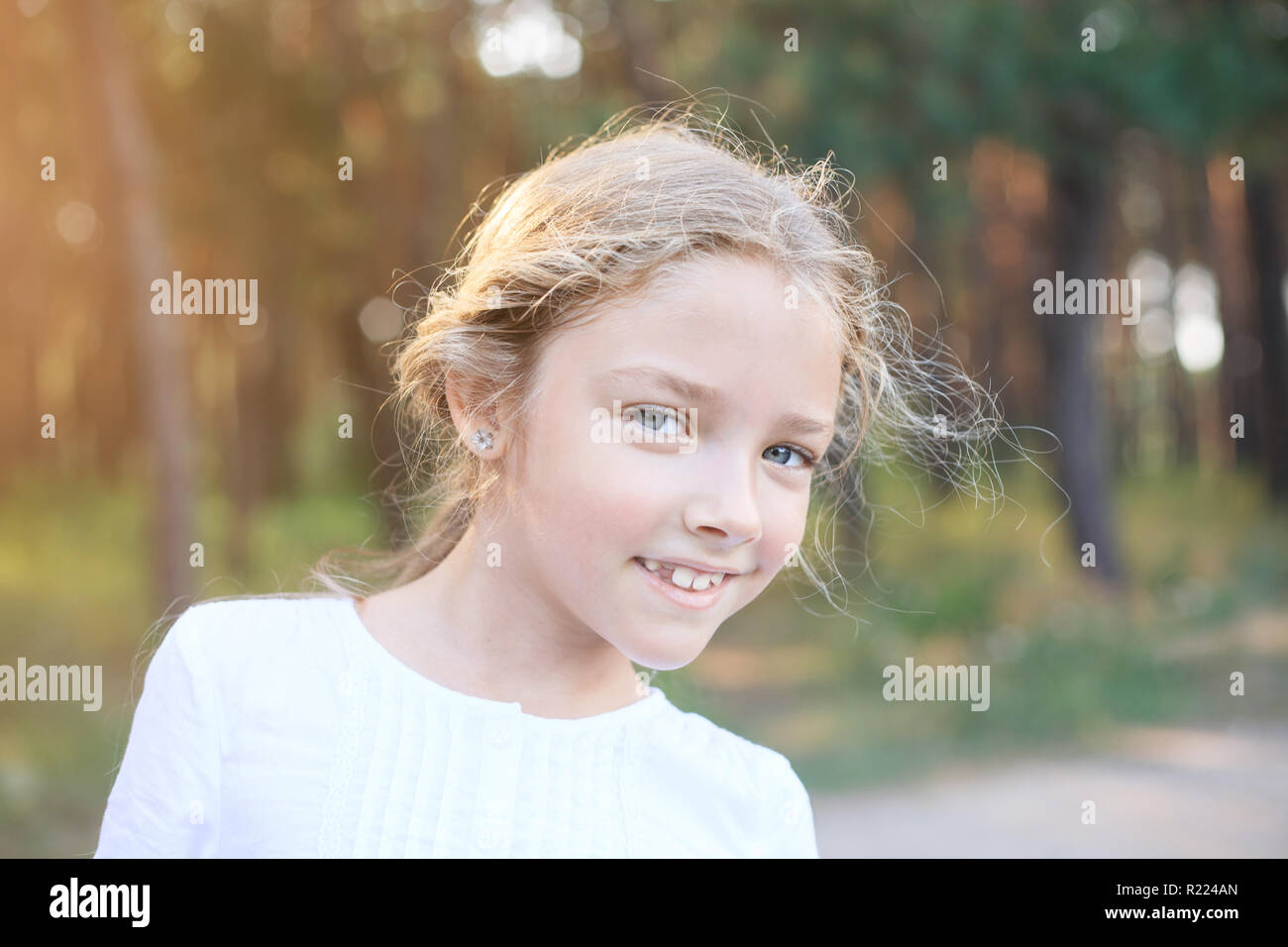 Cute little girl of preschool age in nature. Portrait with positive ...