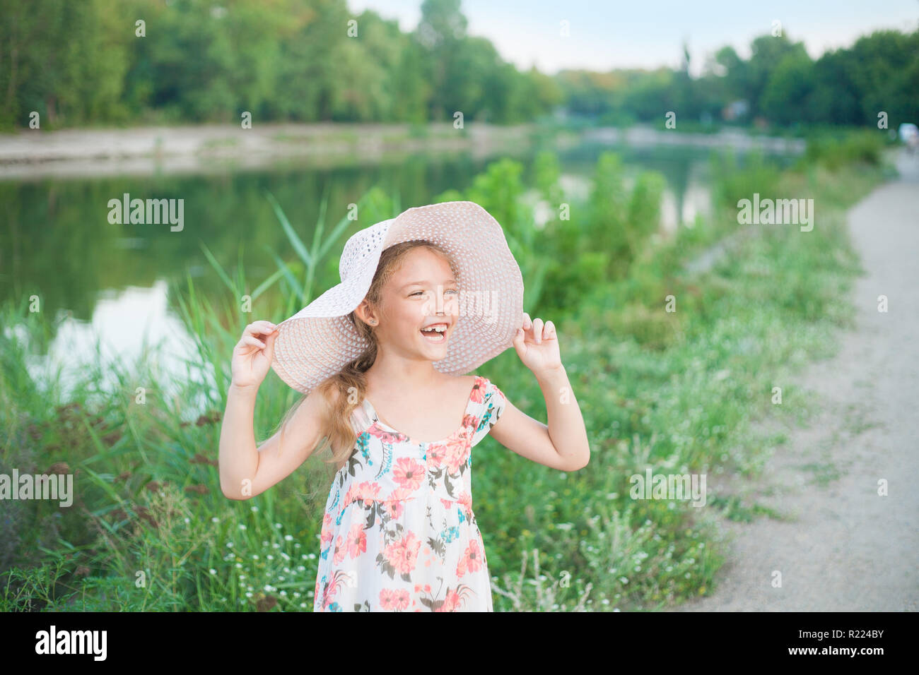 Cute little girl of preschool age in nature. Portrait with positive ...
