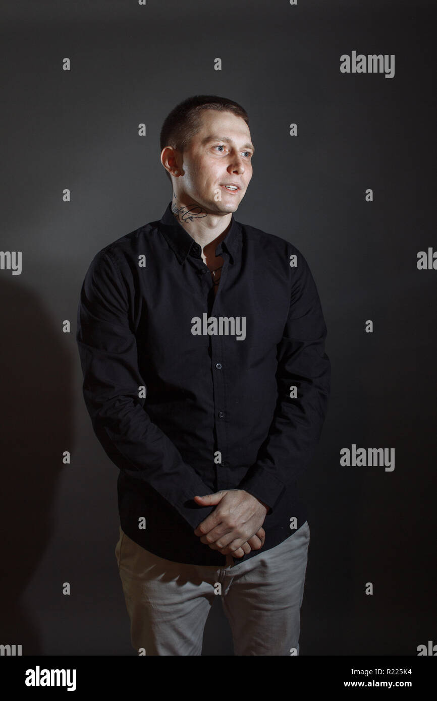 Portrait of determined goodlooking man wearing black shirt, black ...