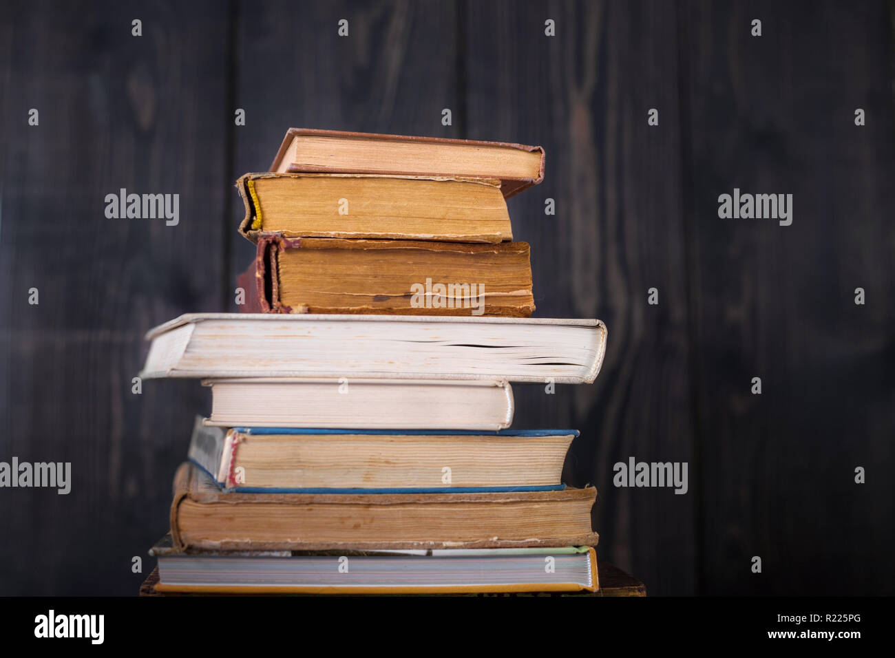 Stack of hardback books on dark wooden background. Back to school Stock ...