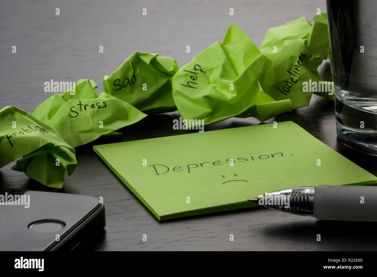 Depression. The word "depression" is written on green sticky note on ...
