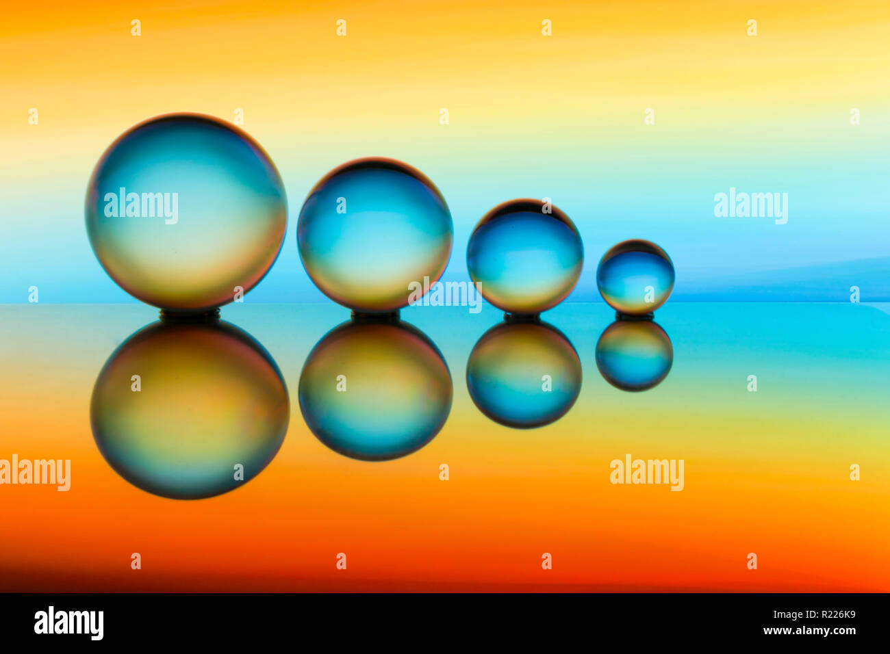 An abstract row of four fortune teller glass ball / balls / lensball ...