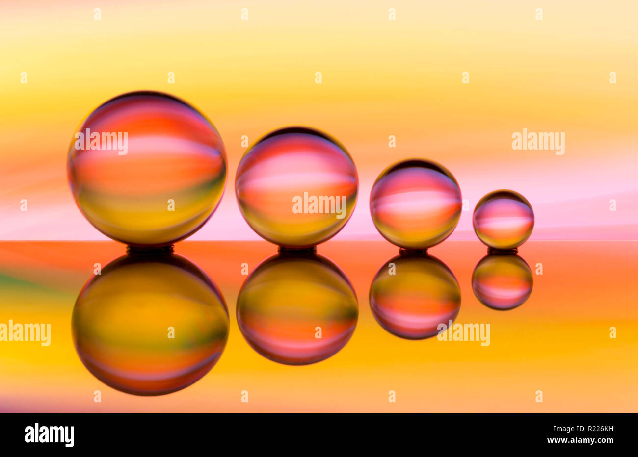 An abstract row of four fortune teller glass ball / balls / lensball ...