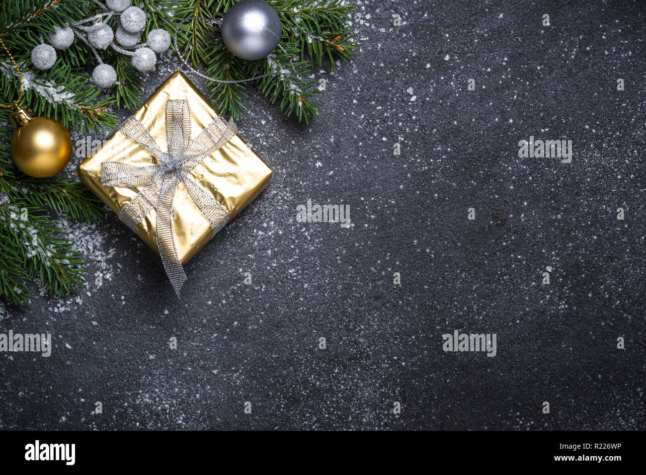 Gold present box and decorations on black stone background Stock Photo ...