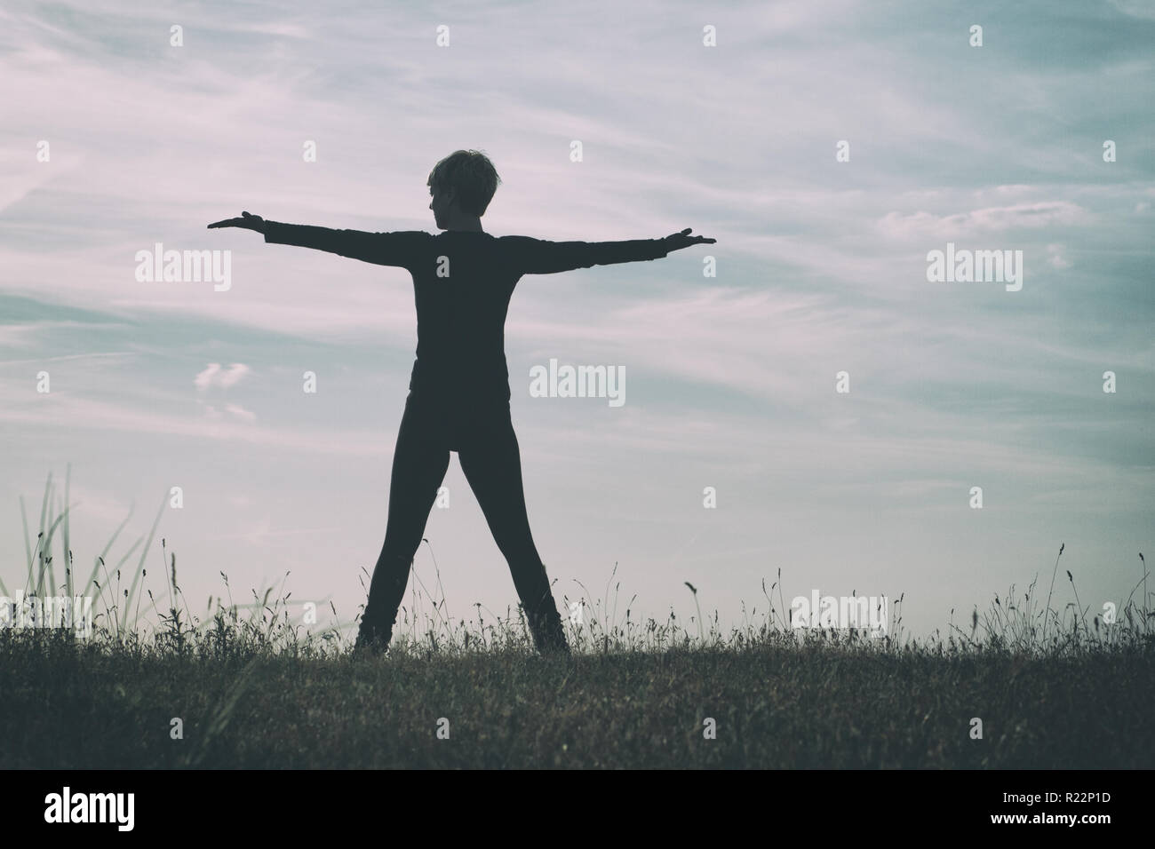 Silhouette young woman arms outstretched hi-res stock photography and ...