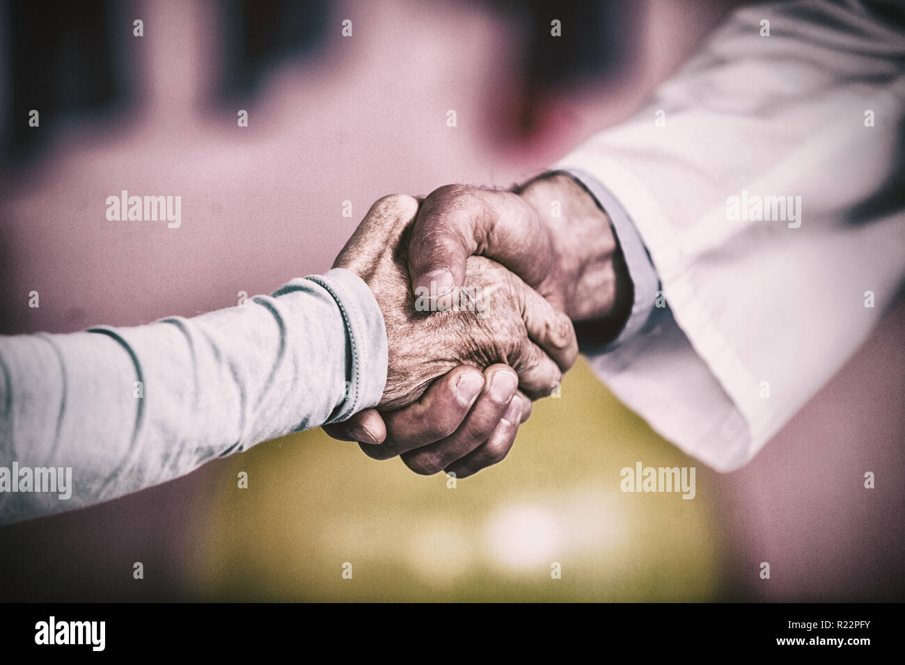 Physiotherapist shaking hands with patient Stock Photo - Alamy