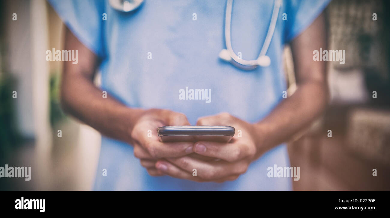 Doctor using mobile phone in hospital Stock Photo - Alamy