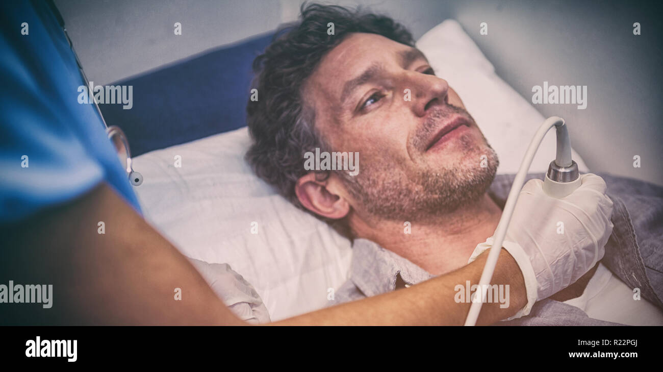 Doctors performing a doppler sonography on patient Stock Photo - Alamy