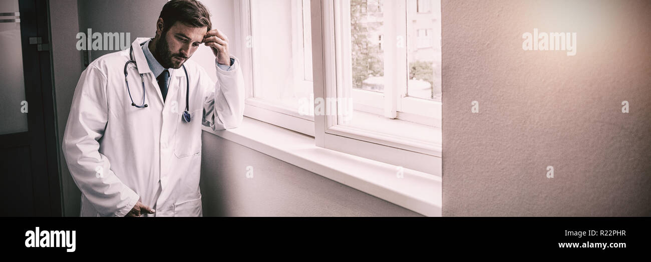 Sad doctor standing in corridor Stock Photo - Alamy